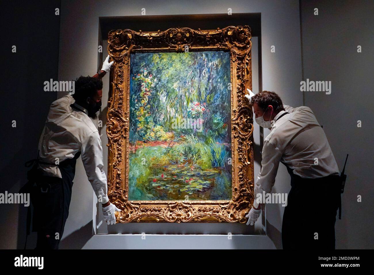 Art handlers adjust Claude Monet's "Coin du bassin aux nympheas" on ...