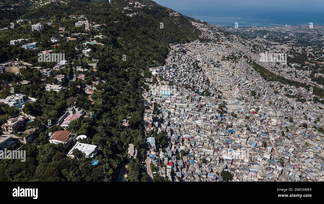 Trees separate an affluent neighborhood, Morne Calvaire, from densely ...
