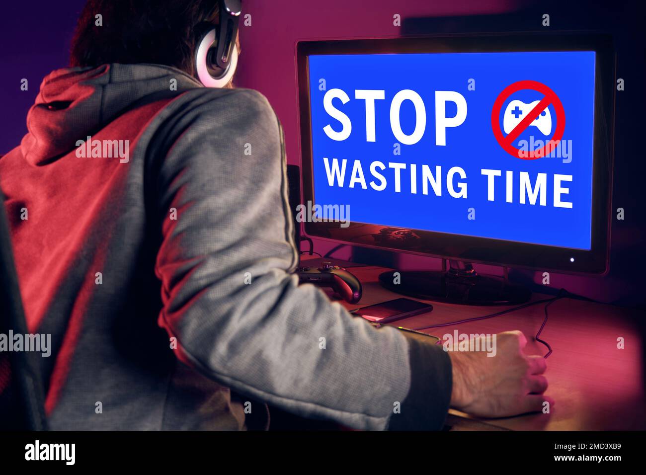 Young man sitting in front of PC screen showing blue screen with ...