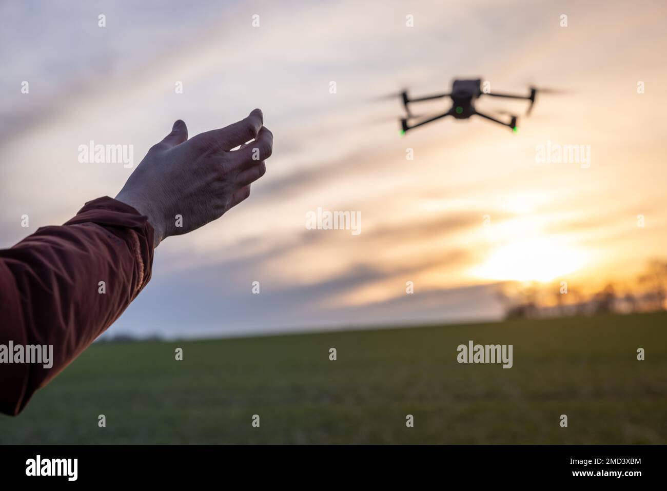 Drone Pilot Launching Drone from Hand at Sunset Stock Photo - Alamy