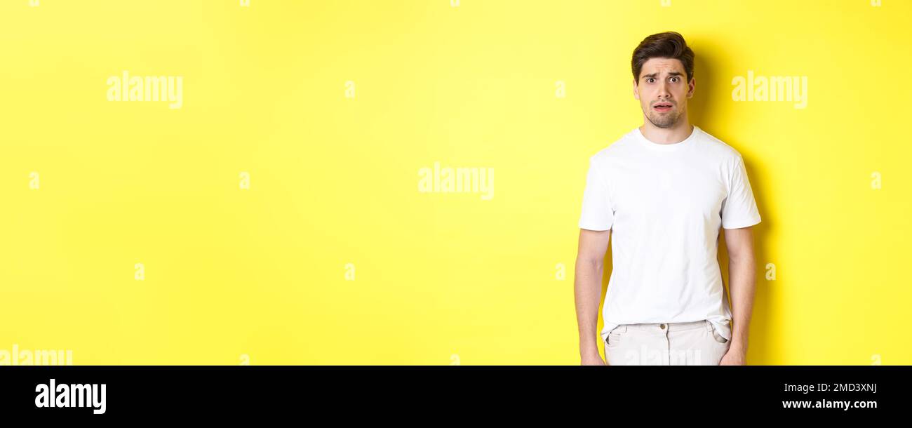 Image of confused and nervous man looking at something strange ...