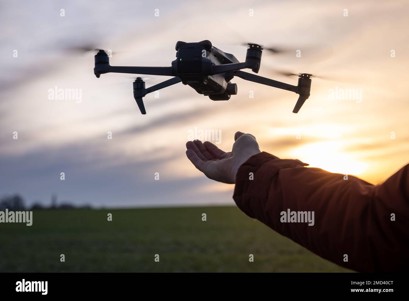 Drone Pilot Launching Drone from Hand at Sunset Stock Photo - Alamy