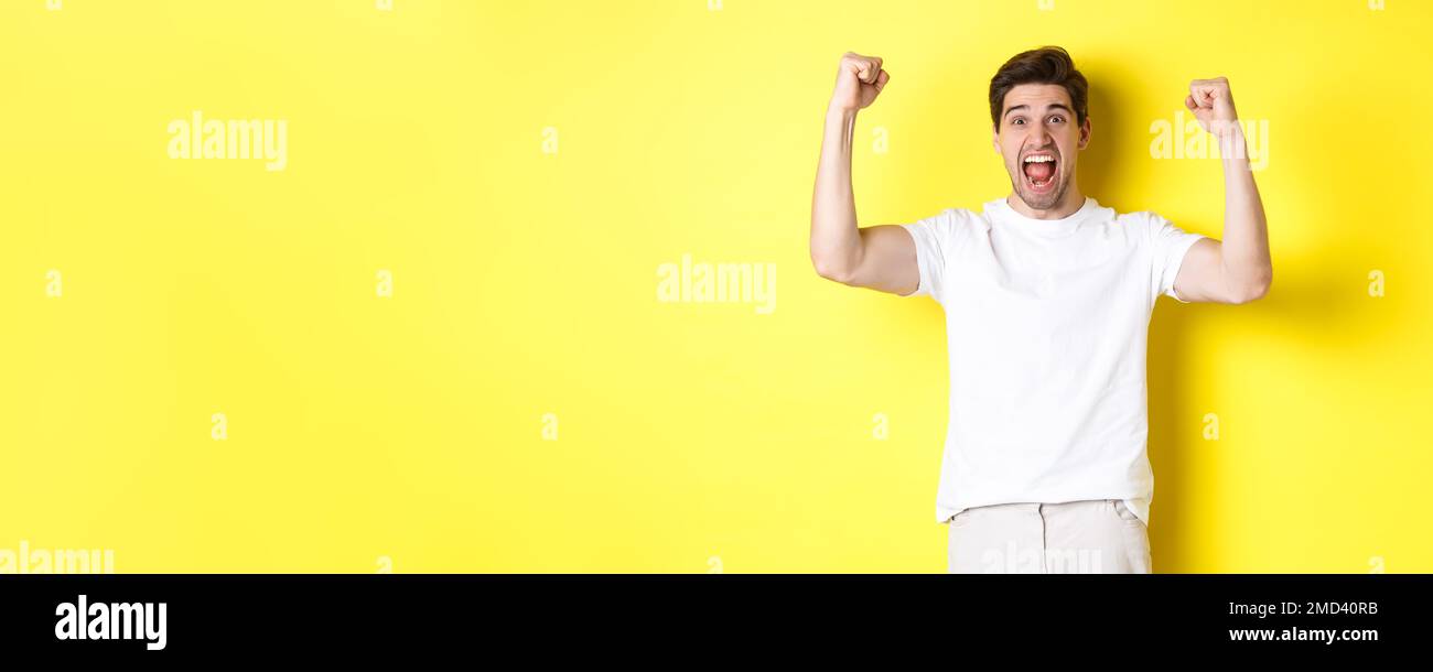 Image of excited man winning, raising hands up and celebrating ...