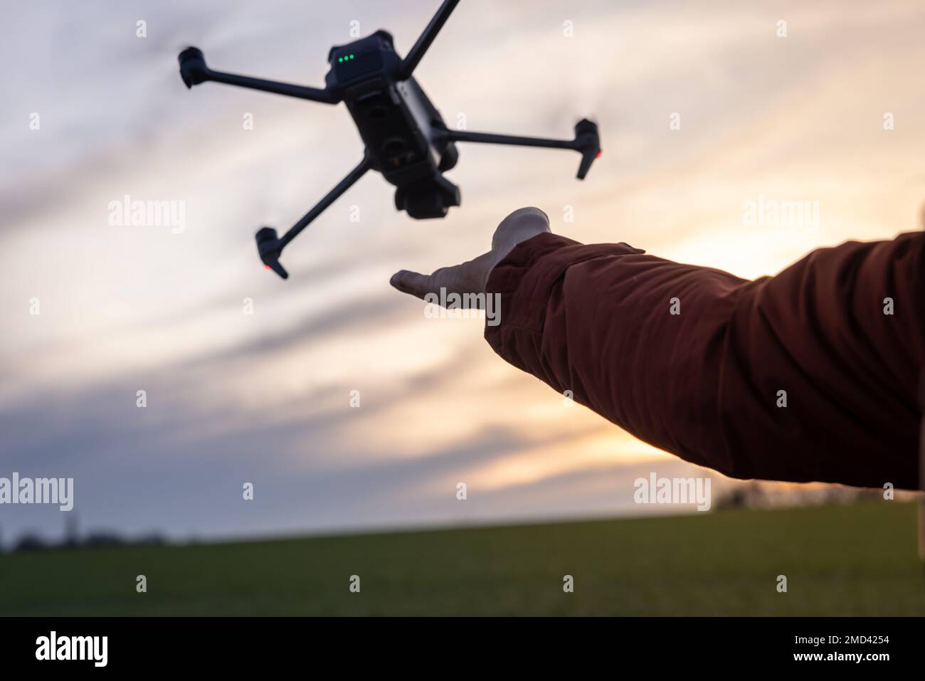Drone Pilot Launching Drone from Hand at Sunset Stock Photo - Alamy