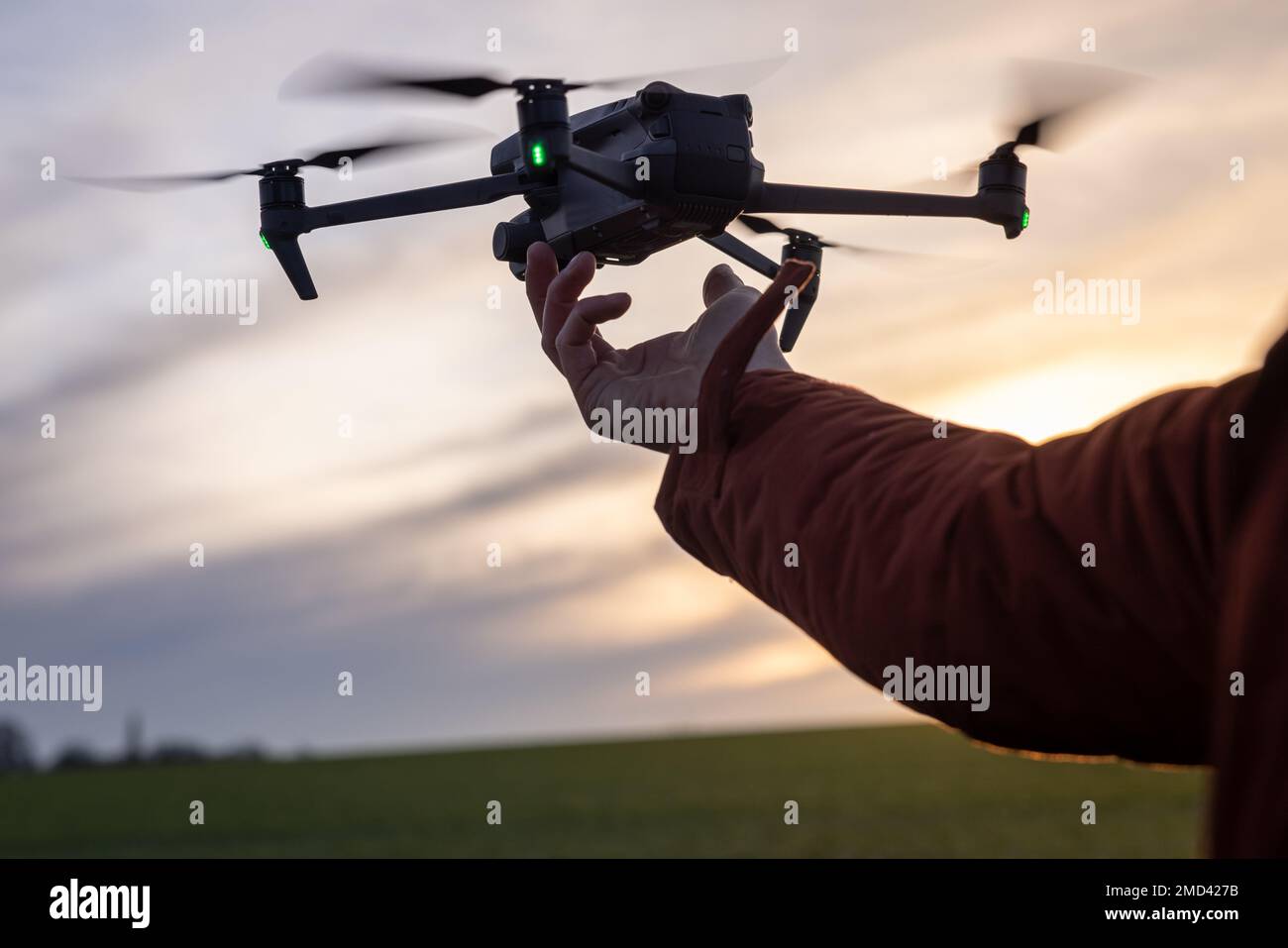 Drone Pilot Launching Drone from Hand at Sunset Stock Photo - Alamy