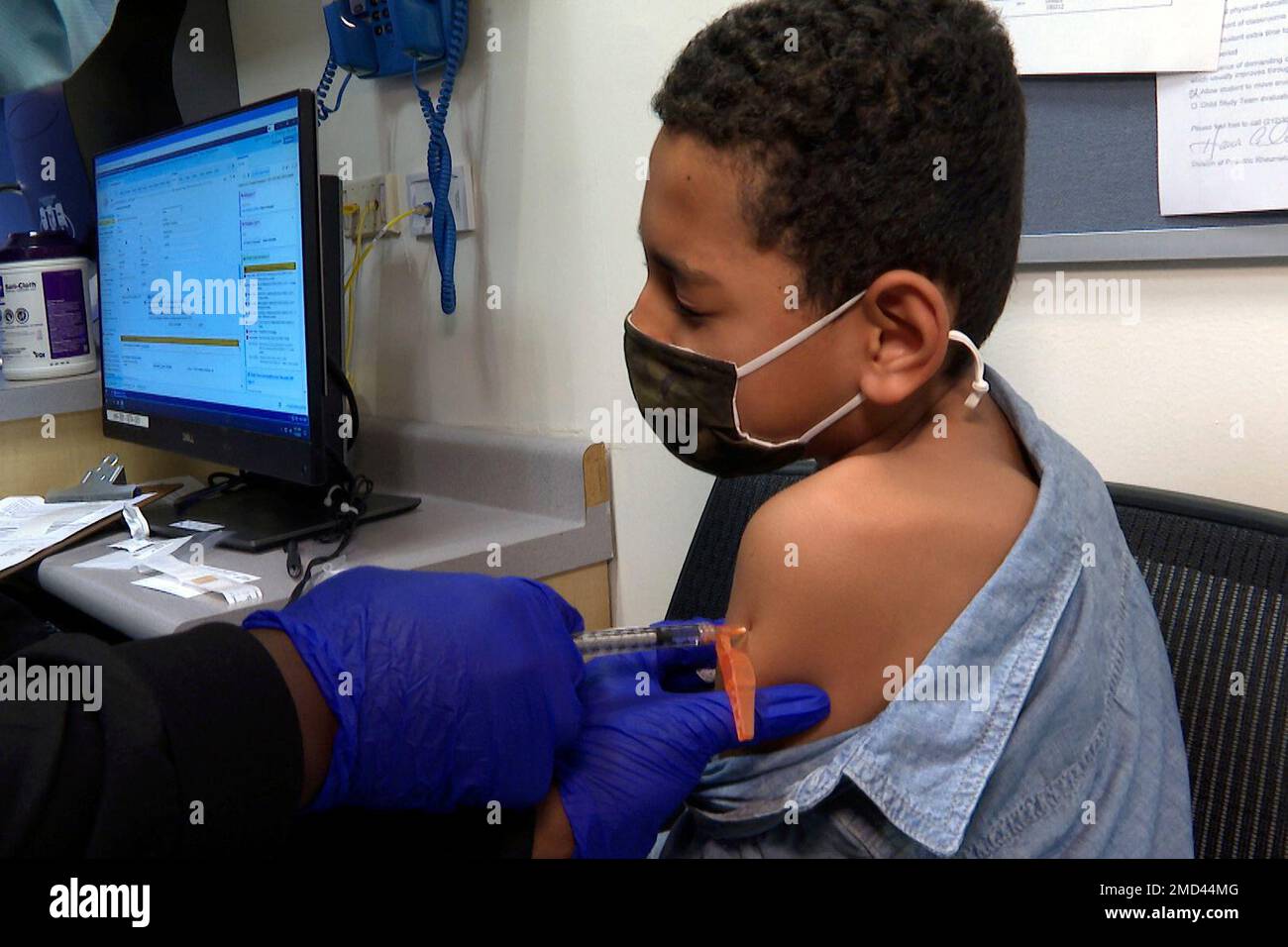 Gael Brown-Madrigal, 10, receives a COVID-19 vaccine shot at NYC Health ...