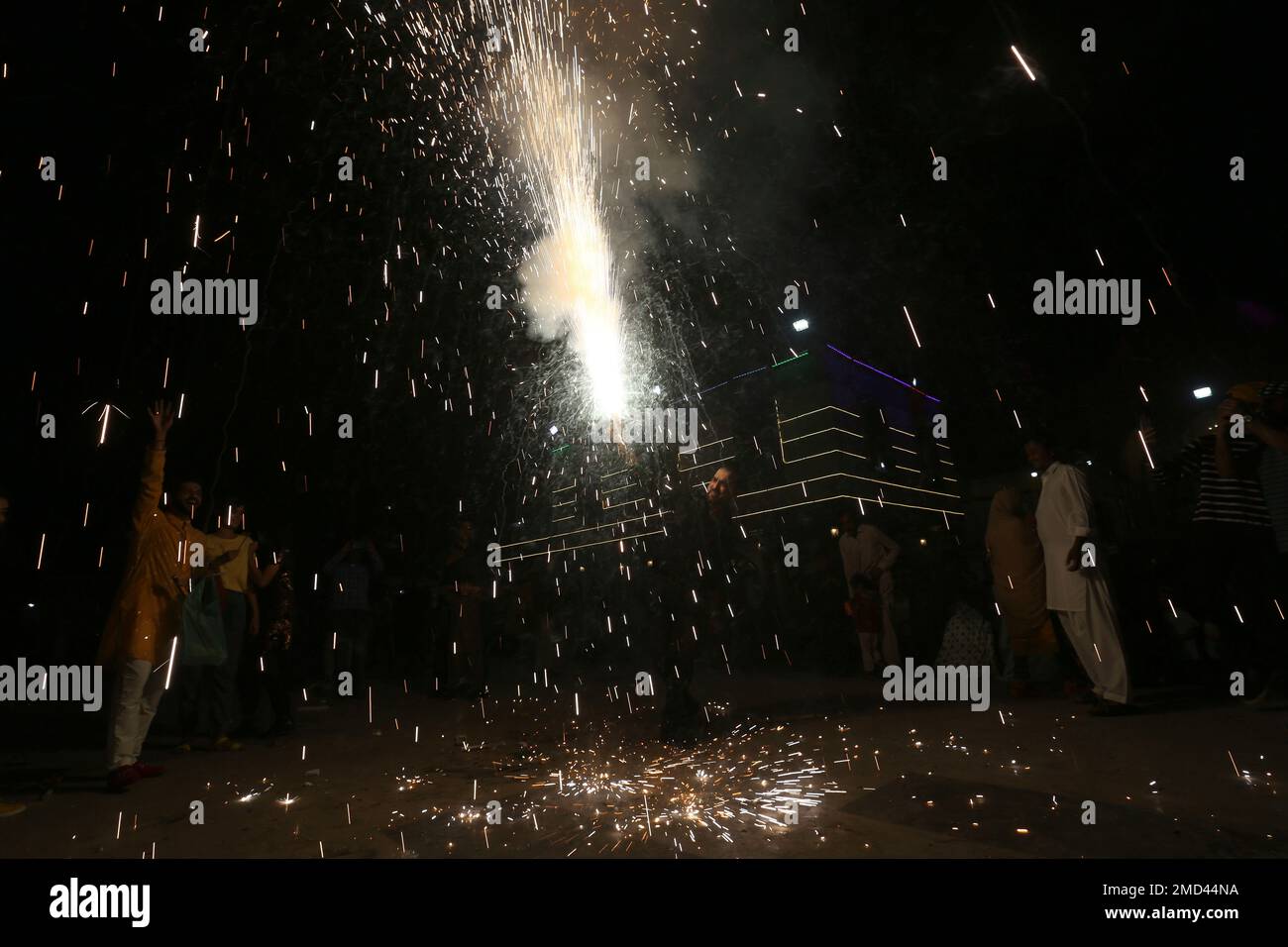 A Hindu holds a firework at a ceremony to celebrate Diwali, the ...