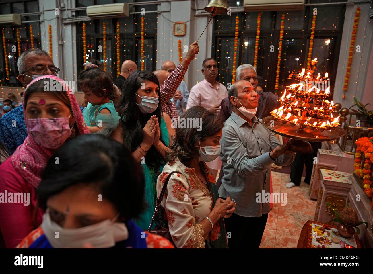 Hindu devotees light oil lamps at a temple during Diwali, the festival ...
