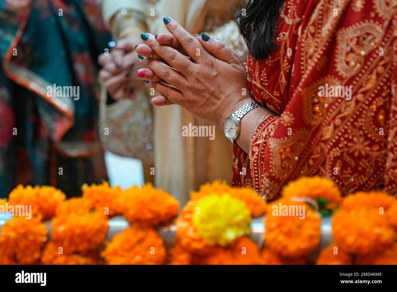 Hindu devotees pray at a temple during Diwali, the festival of lights ...