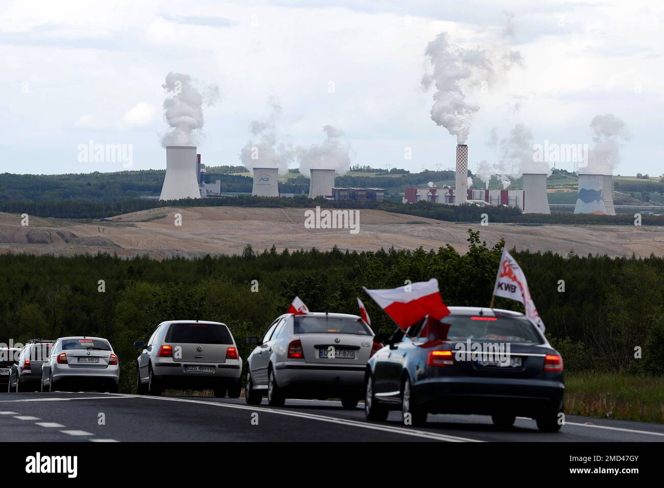 FILE - Cars drive slowly to block a border between Czech Republic and ...