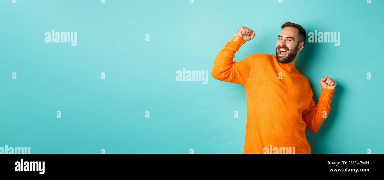 Happy man raising arm, feeling like winner, triumphing and celebrating ...