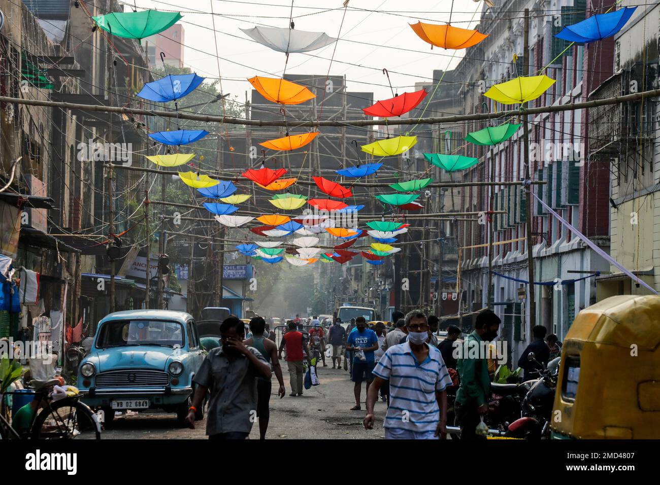 A road decorated is with umbrellas during Diwali, the Hindu festival of ...