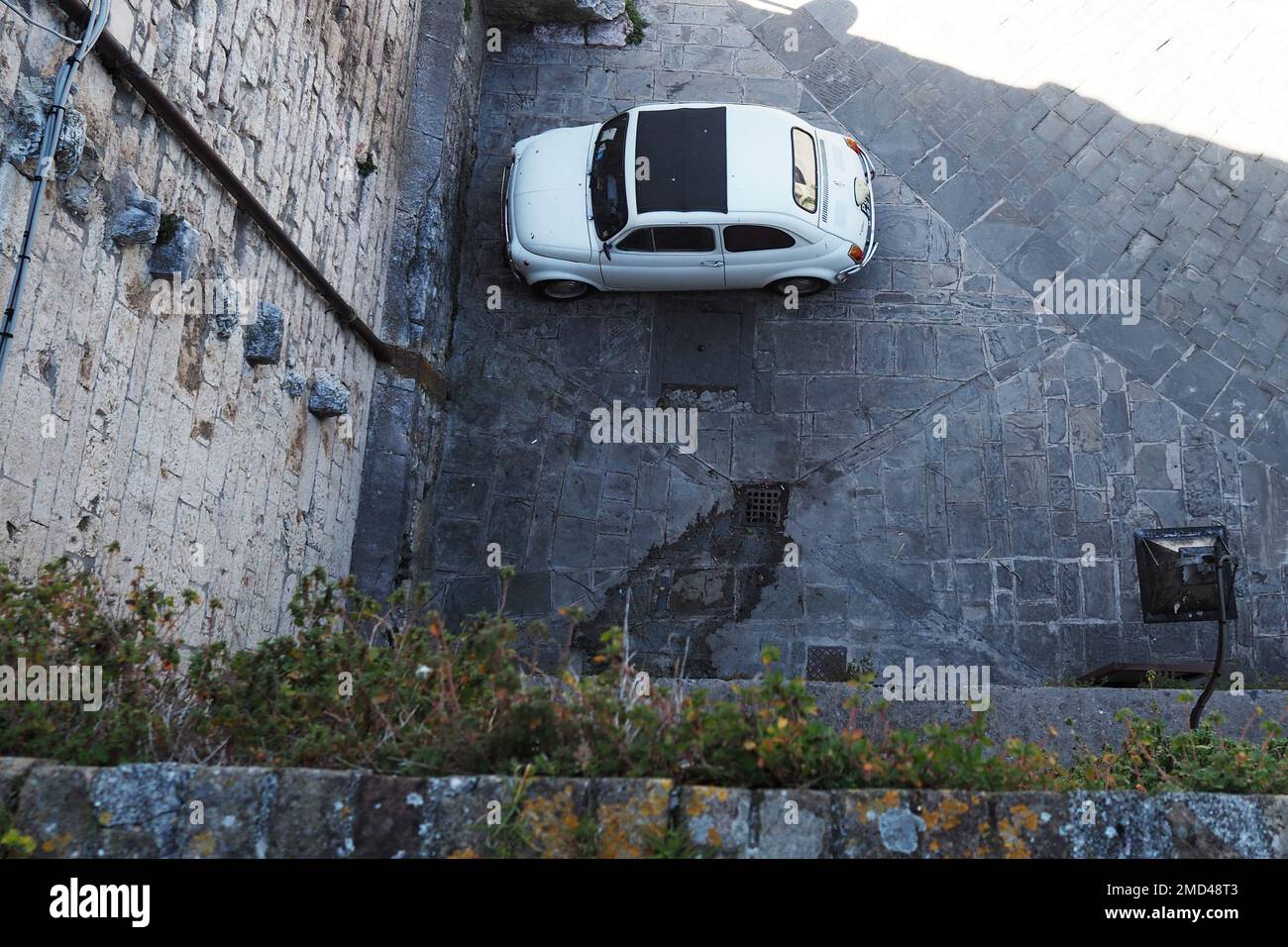 iconic Italian car 'Fiat 500' parked in the medieval village of Gubbio ...