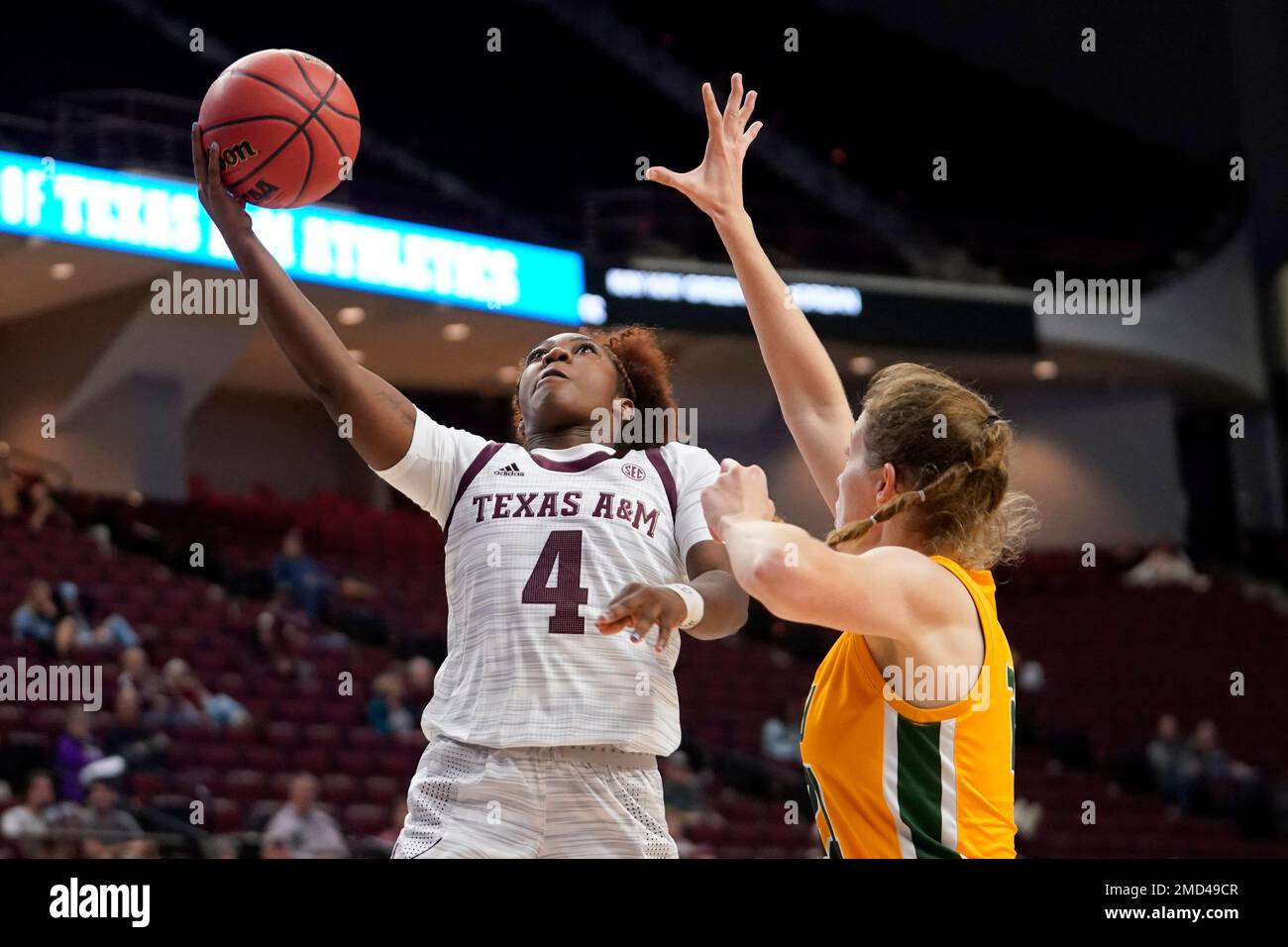 Texas A&M guard Kay Kay Green (4) shoots a layup as Oklahoma Baptist ...