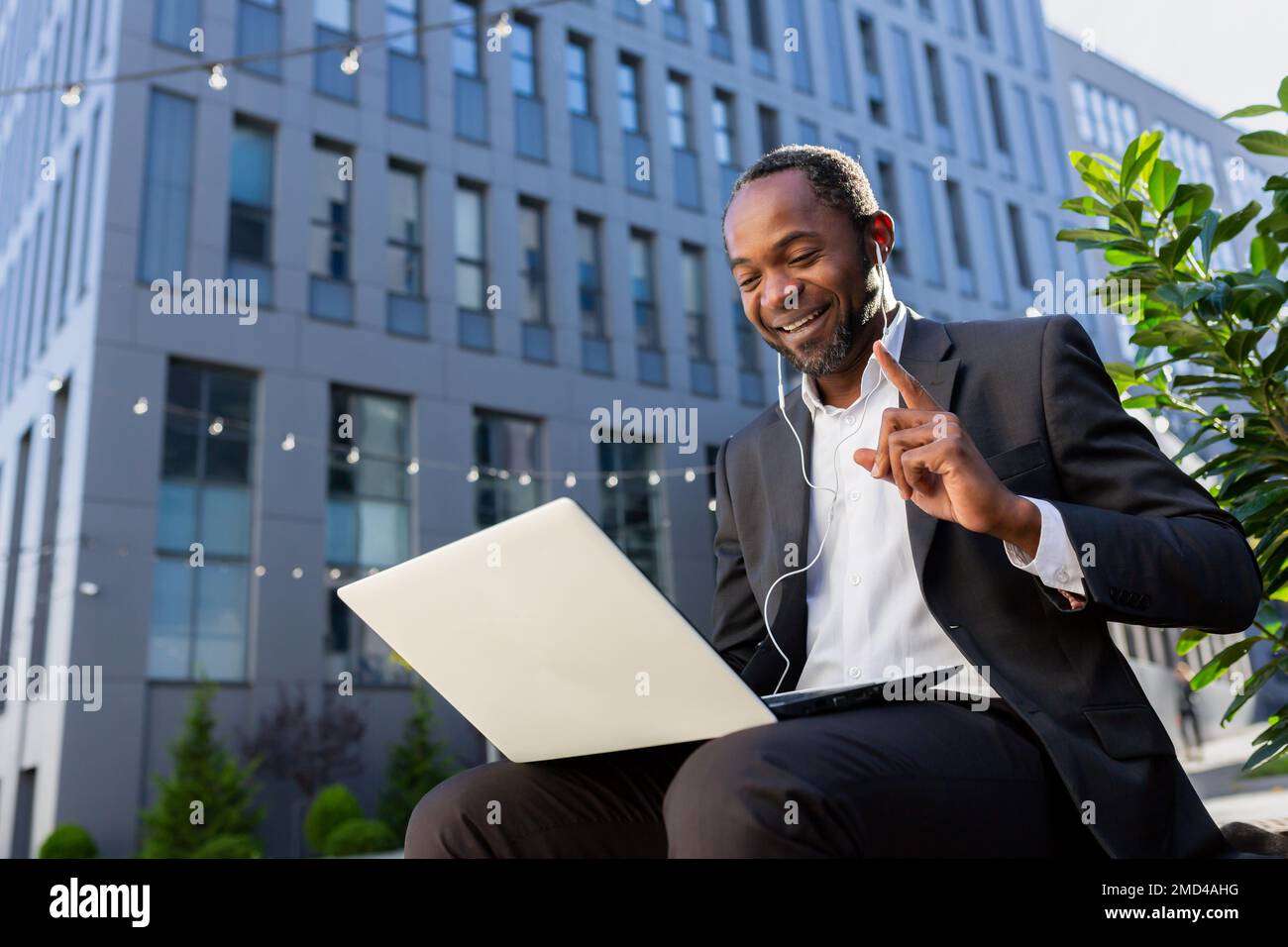 African american businessman outside office building talking to ...
