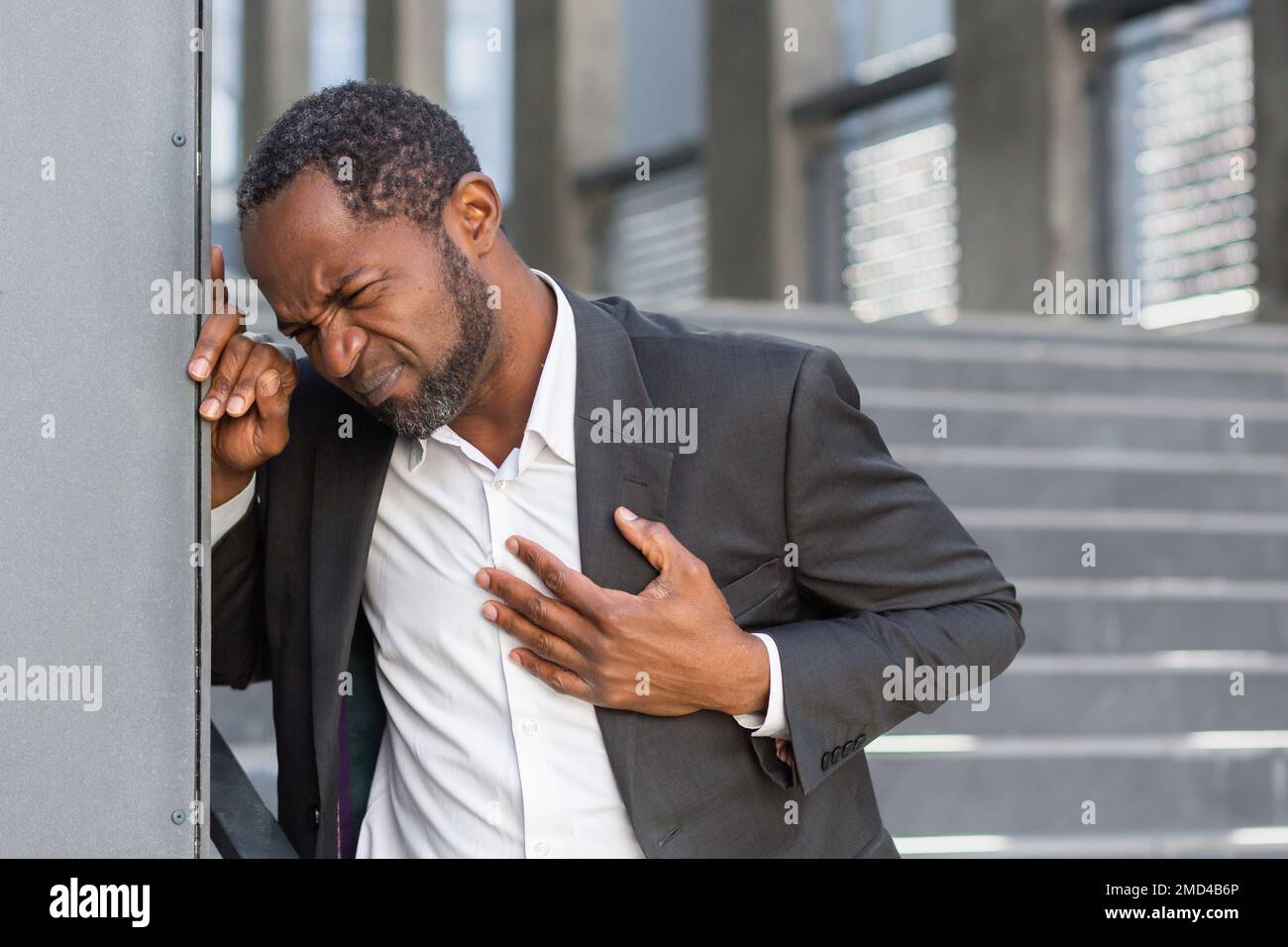 Heart attack, African American man has severe chest pain, businessman ...