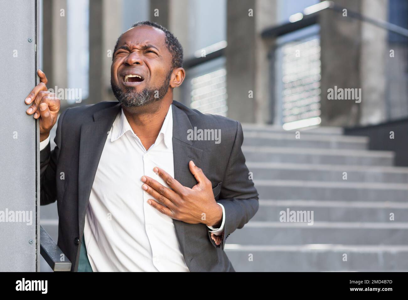 Heart attack, African American man has severe chest pain, businessman ...
