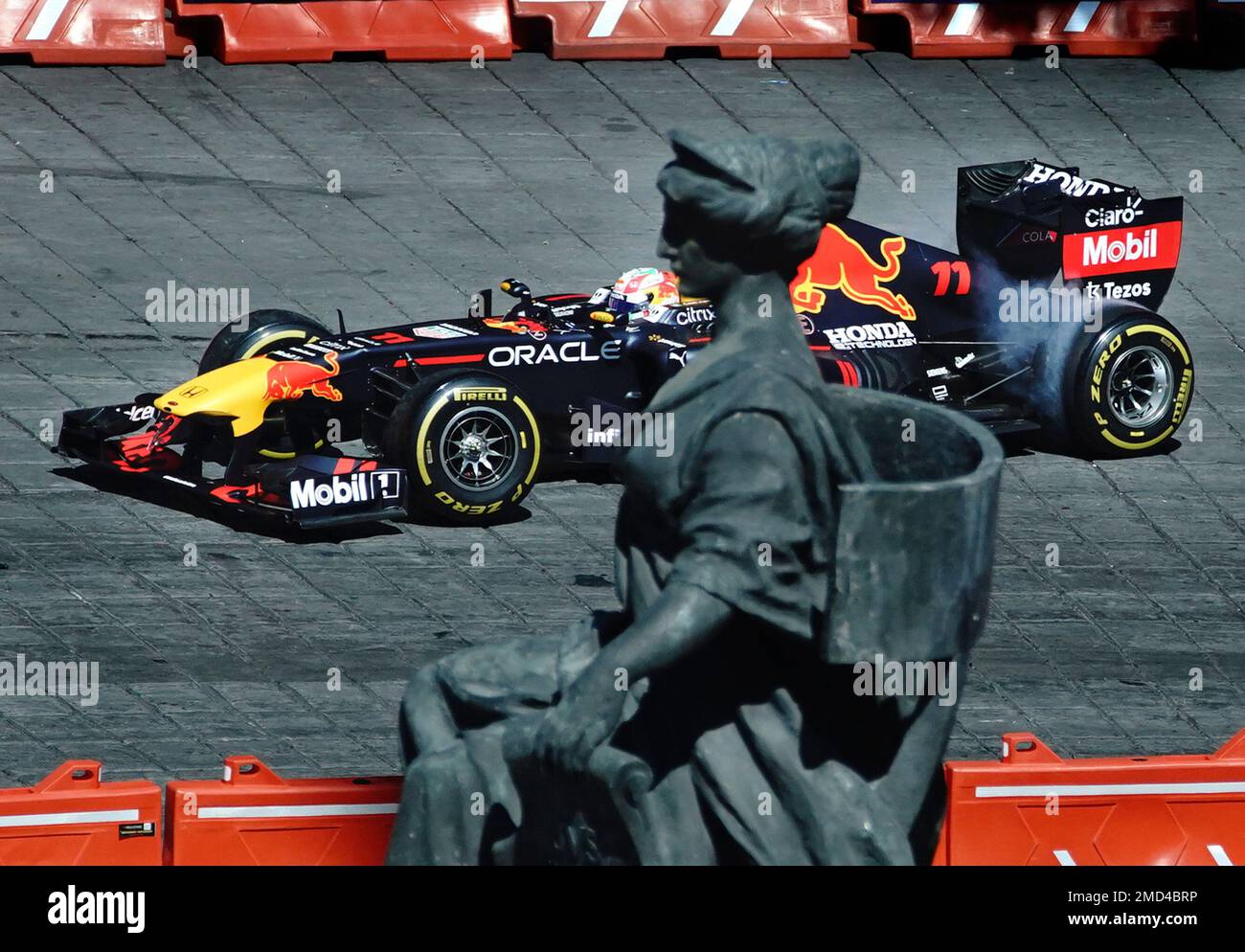 Mexican Formula One Red Bull driver Sergio "Checo" Perez waves as he drives in an exhibition ...