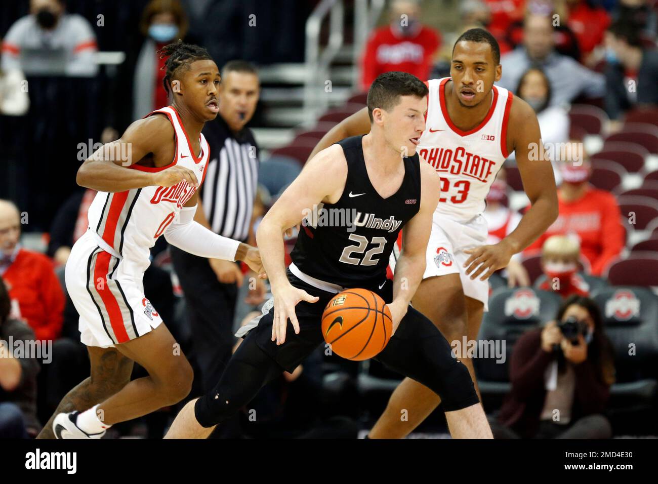 Indianapolis guard Cory Miller, center, drives between Ohio State guard ...