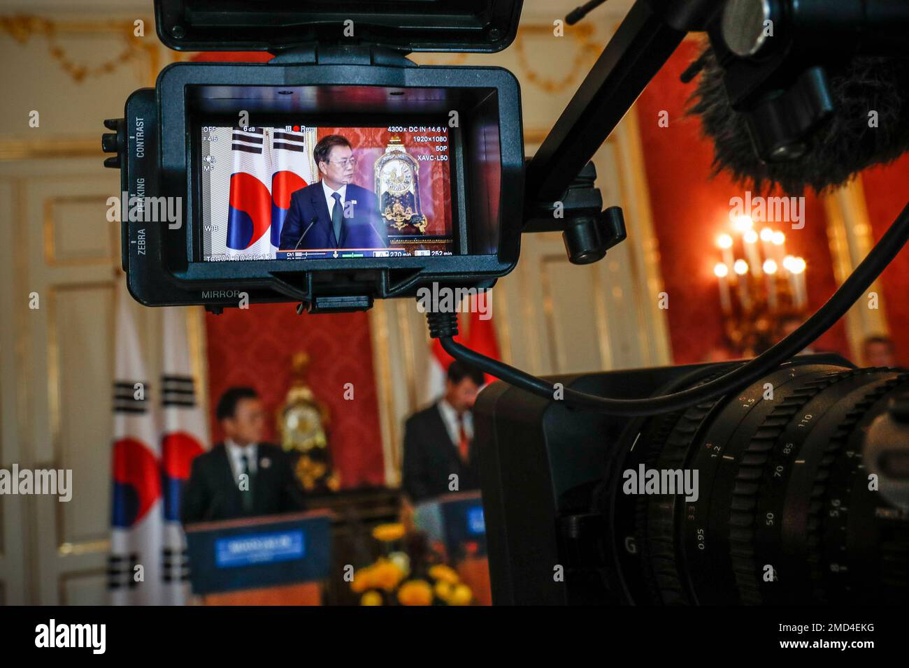 Seen on a TV camera monitor, South Korea President Moon Jae-in, left ...