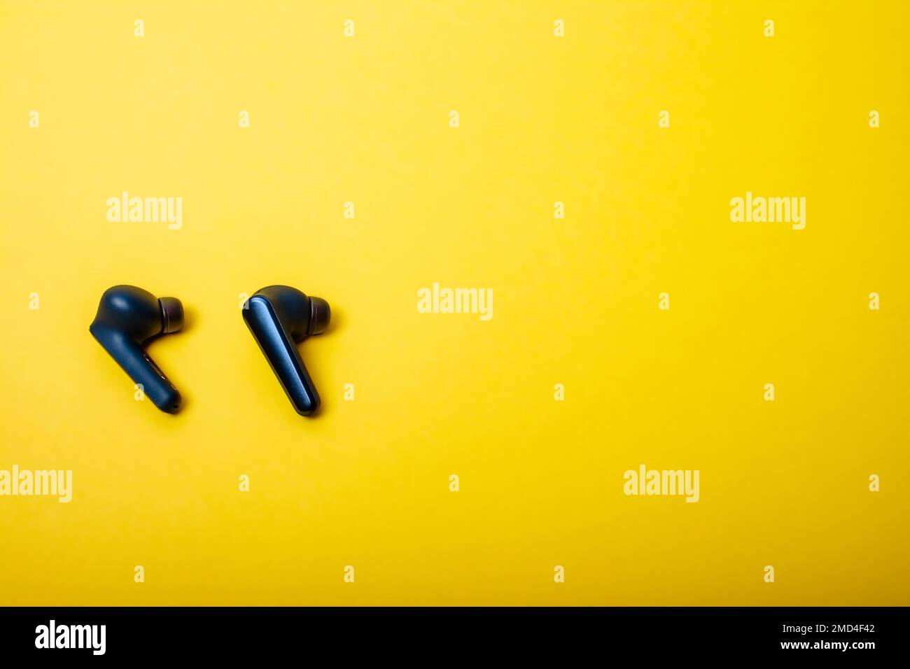 Blue wireless bluetooth earbuds or earphone with charging case on a ...