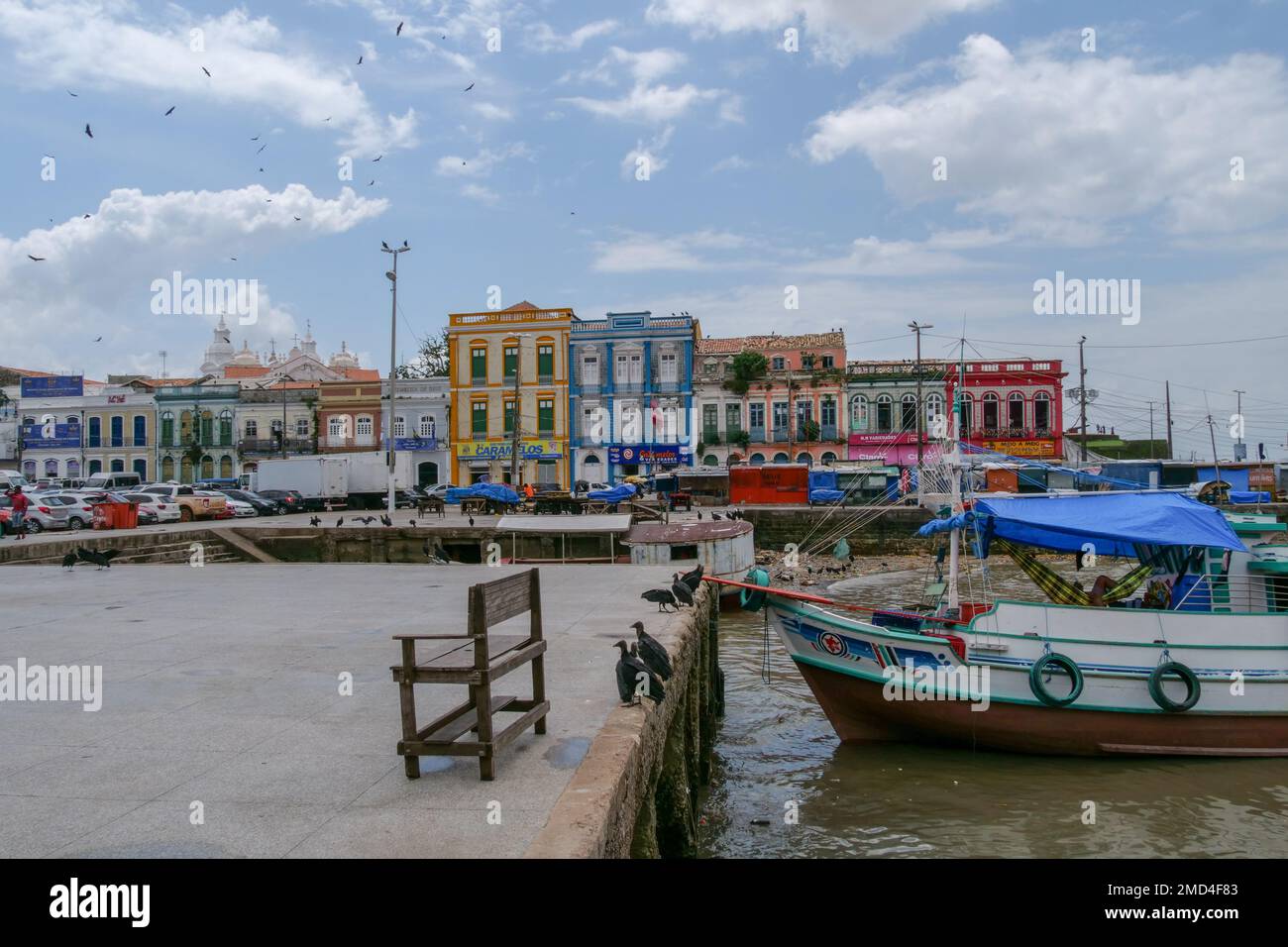 Boat and harbour with colorful historic buildings in the background ...
