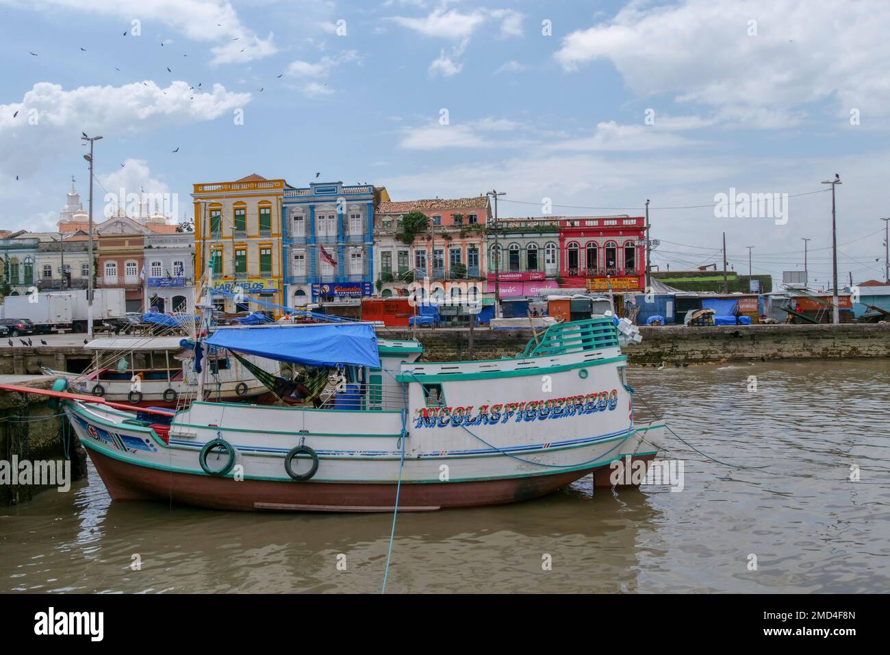Boat and harbour with colorful historic buildings in the background ...