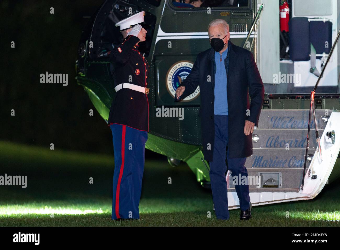 President Joe Biden salutes a Marine Corps honor guard as he arrives at ...