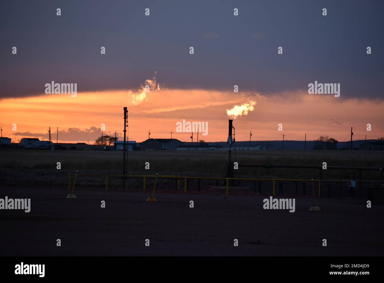 Flares are seen burning natural gas on a crude oil well pad east of New ...
