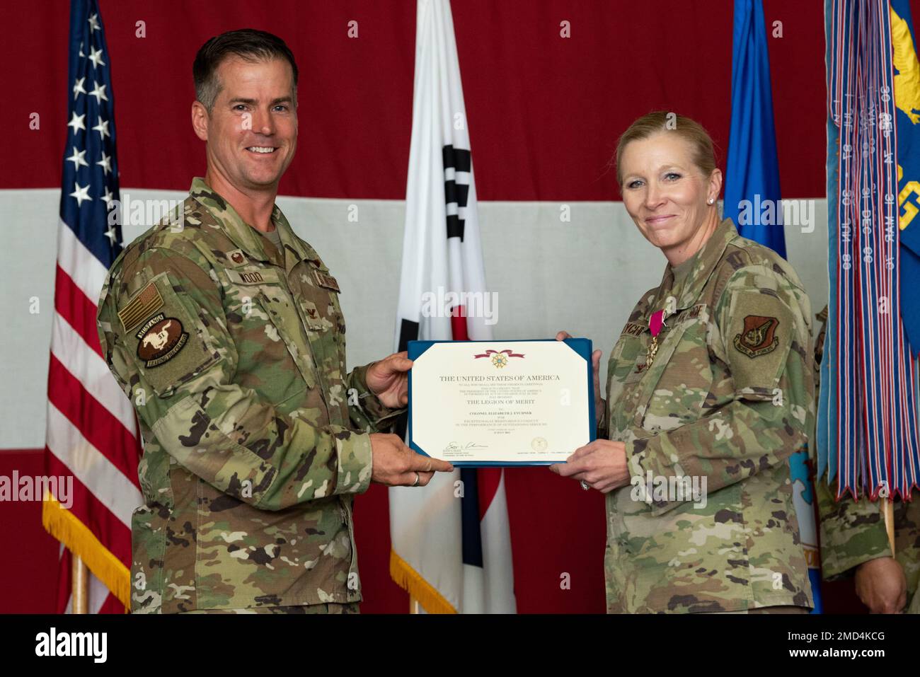 Col. Joshua Wood, 51st Fighter Wing commander, presents Col. Jonelle Eychner, 51st Mission ...