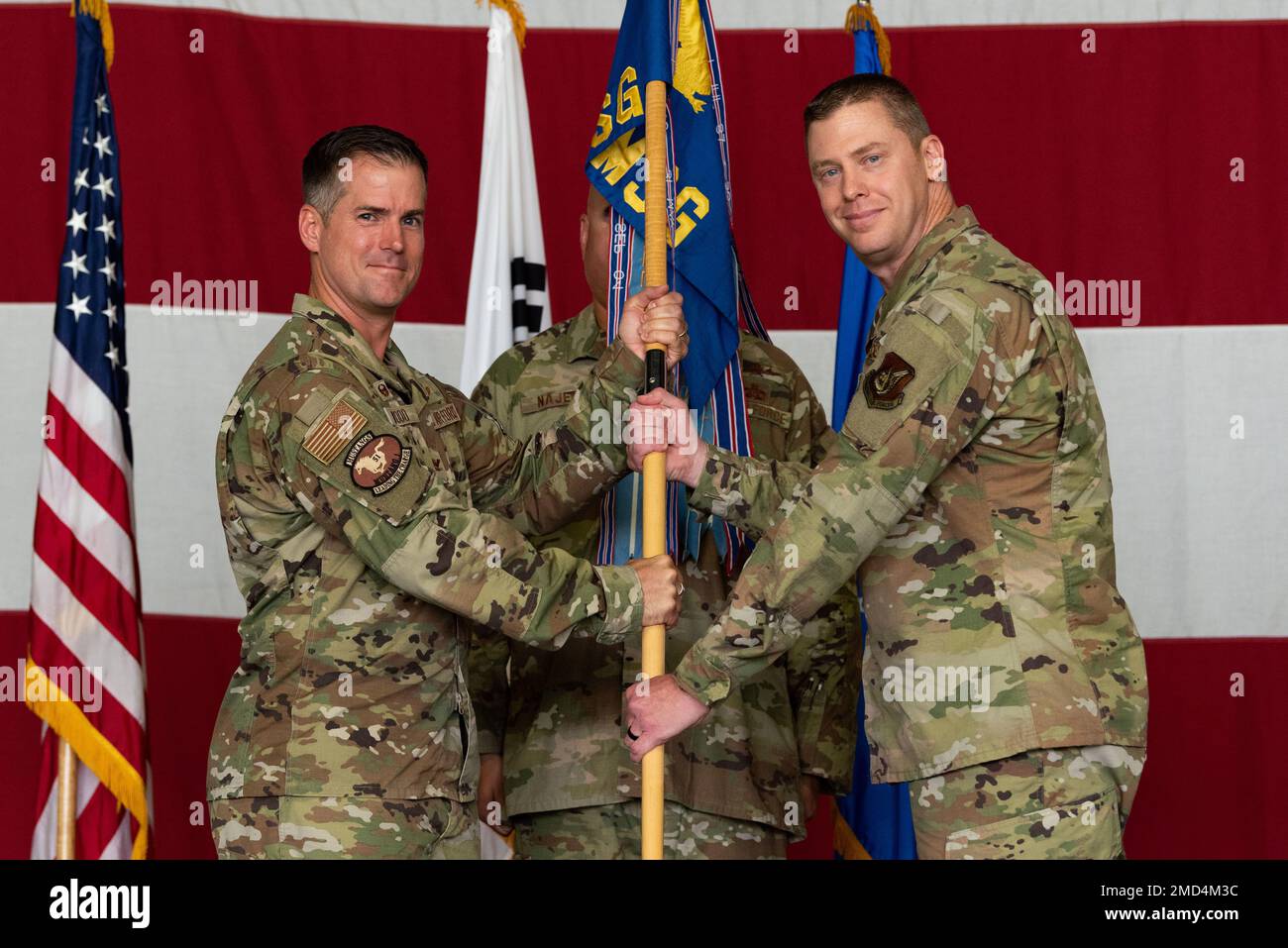 Col. Joshua Wood, 51st Fighter Wing commander, passes the guidon to Col. Kyle Grygo, 51st ...