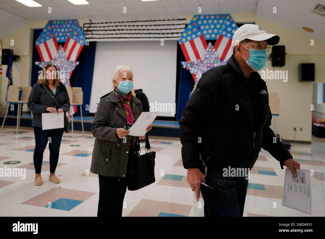 Voters wait in line to vote at a school in Midlothian, Va., Tuesday ...