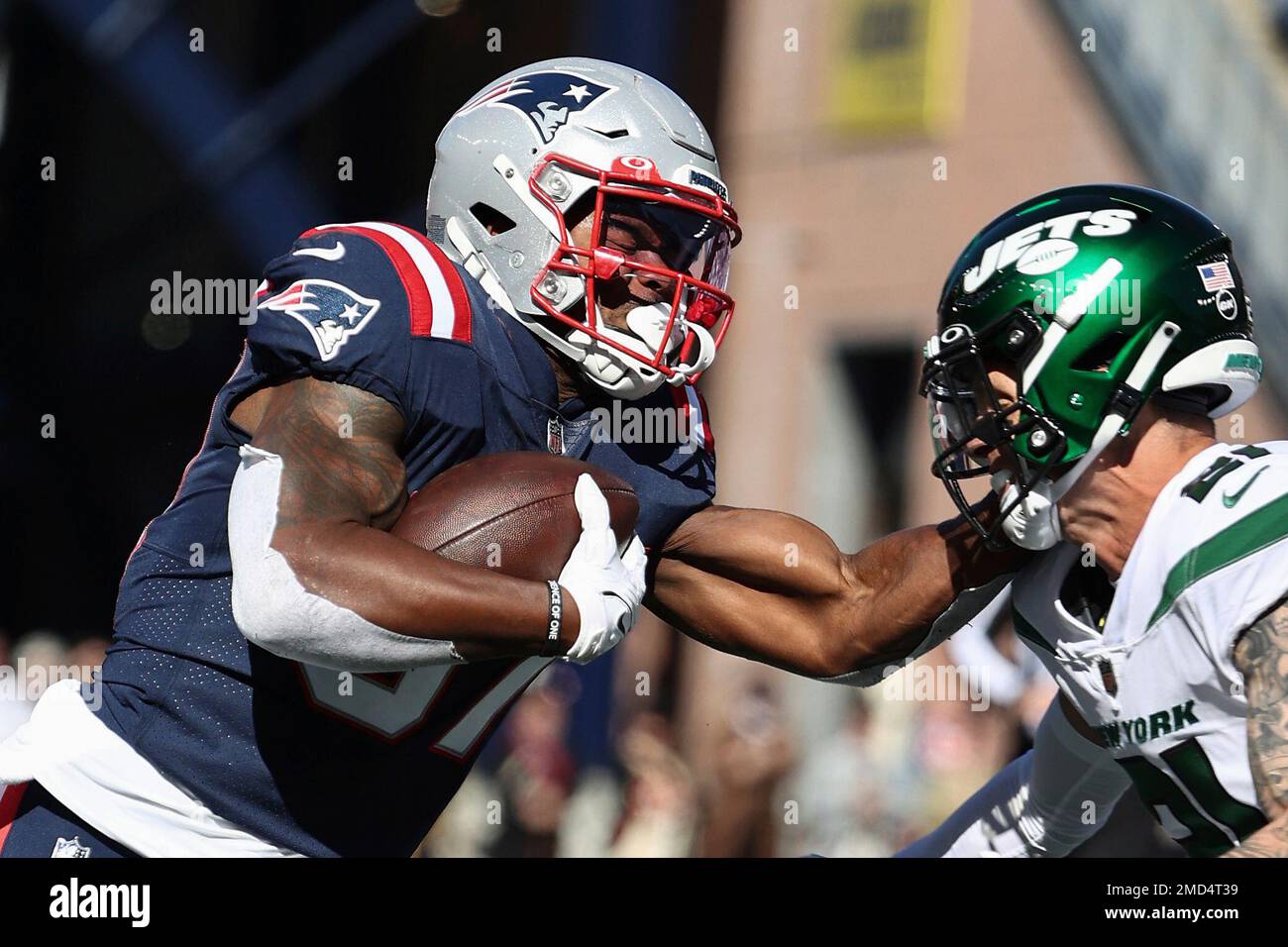 New England Patriots' Damien Harris runs against New York Jets' Ashtyn ...
