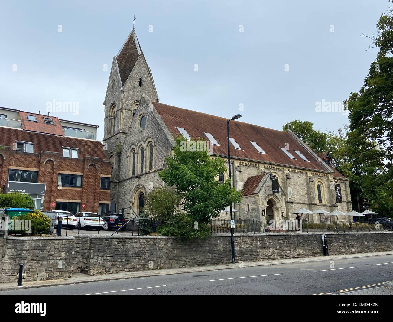 An old church and other buildings behind a stone fence Stock Photo - Alamy