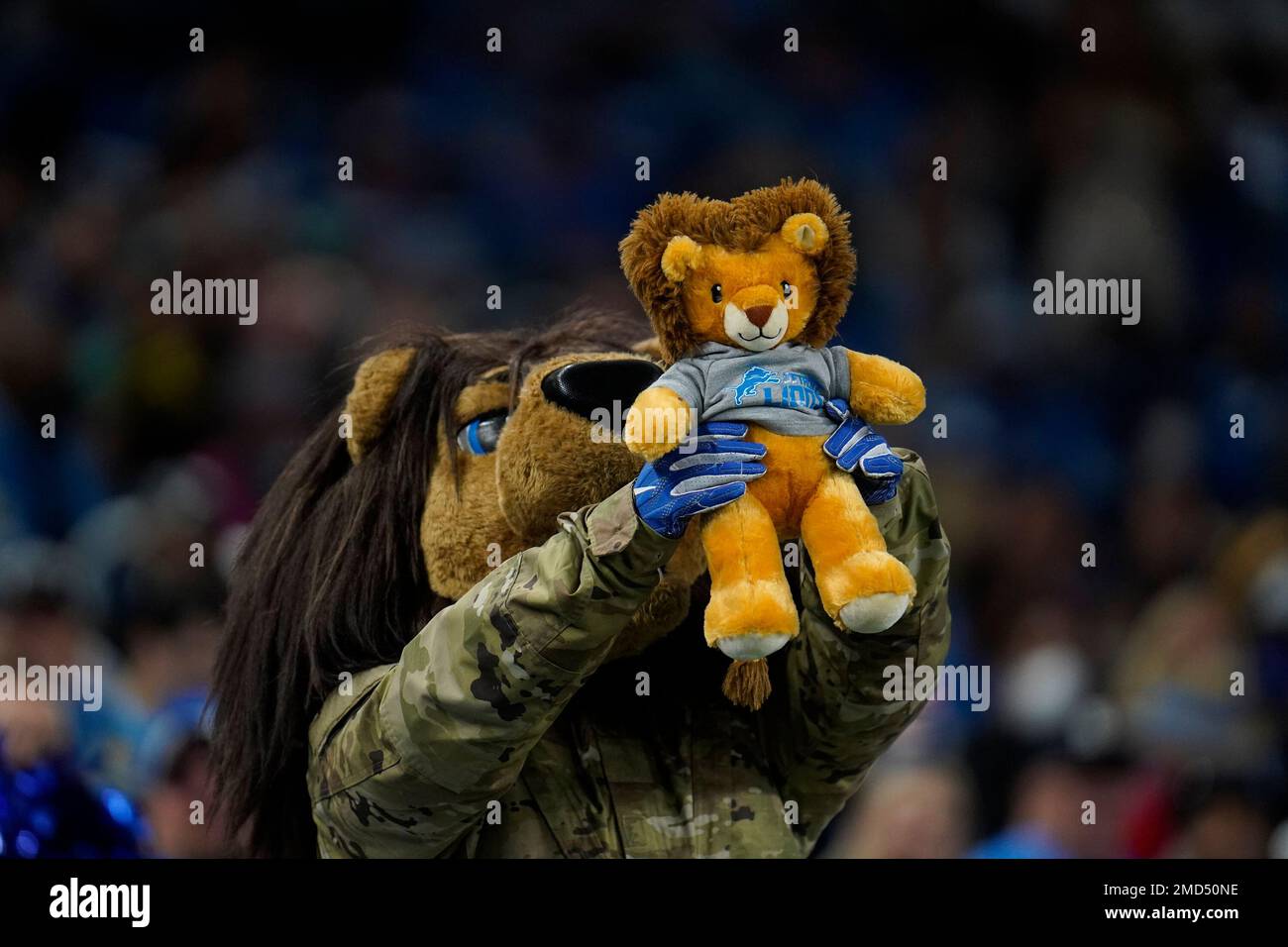 Detroit Lions mascot Roary holds up a stuffed lion toy during an NFL ...