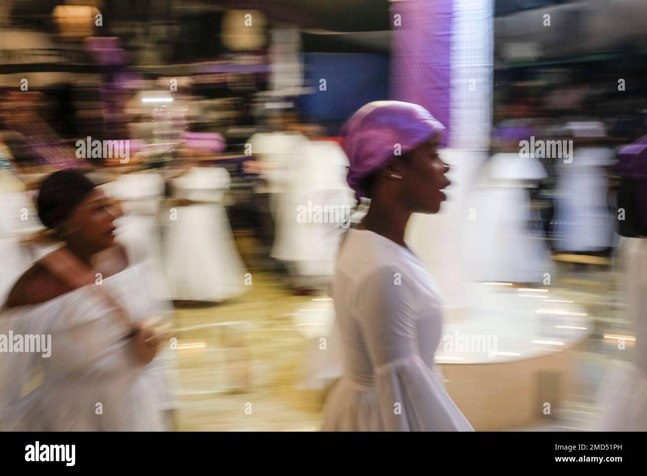 A woman dances as she signs during a Vodou ceremony in the Petion-Ville ...