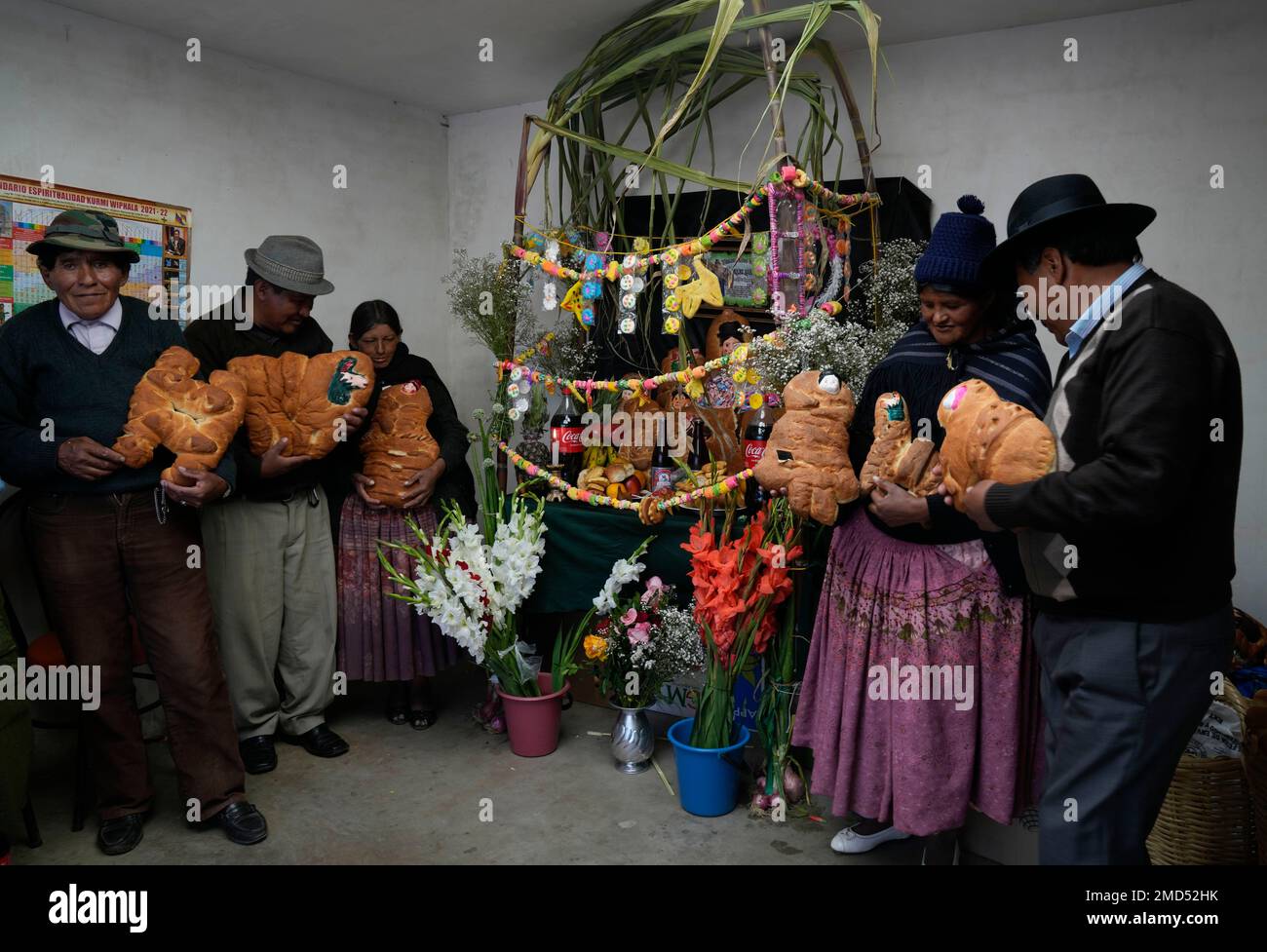 The Ali and Rios family hold traditional “Tantawawas,” bread shaped as ...