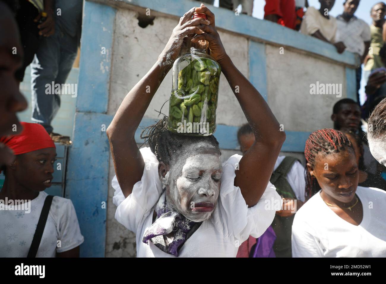 A person believed to be possessed by a Gede spirit attends a ceremony ...
