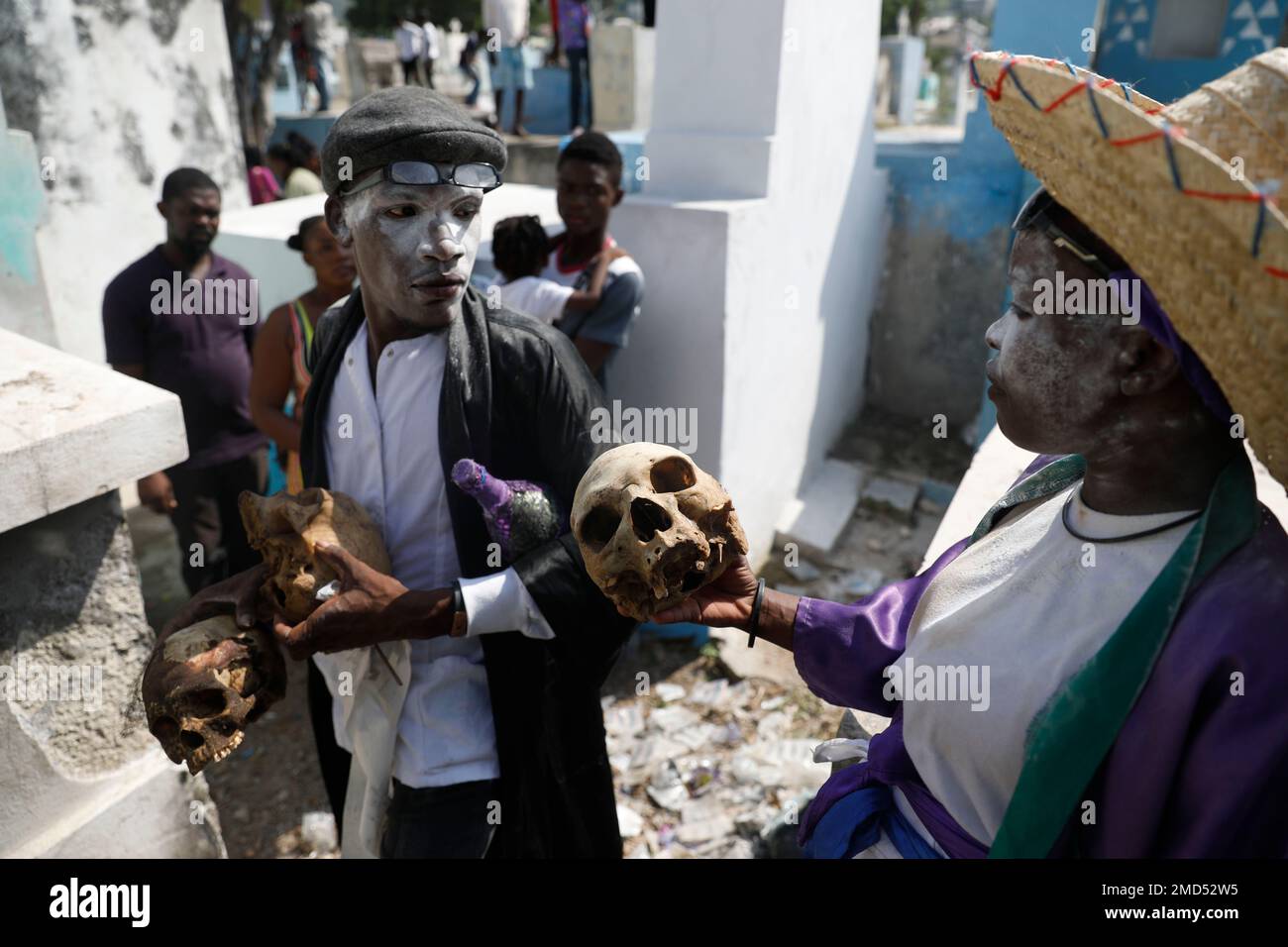 People believed to be possessed a Gede spirit hold human skulls during ...