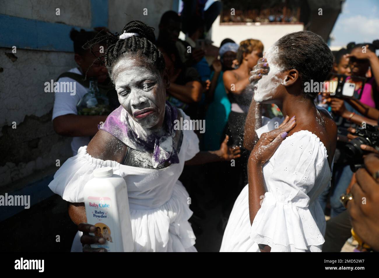 Persons believed to be possessed by a Gede spirit douse themselves with ...