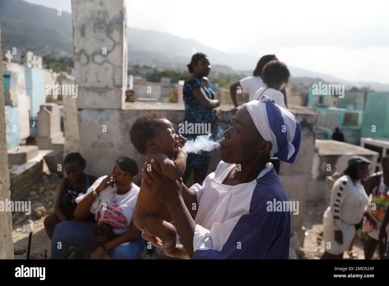 A Vodou priestess claiming to be possessed by a Gede spirit treats a ...