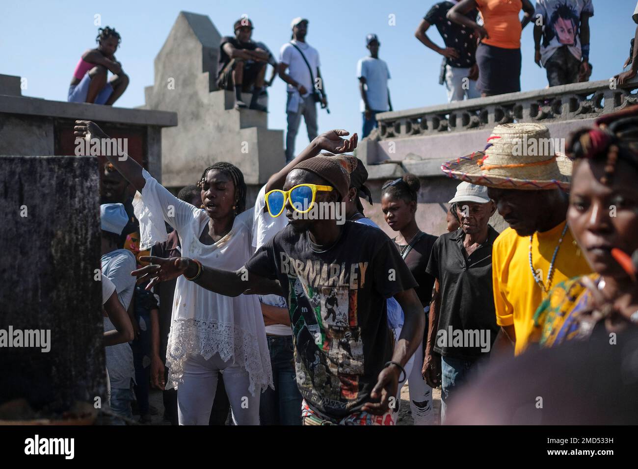 People attend a ceremony honoring the Vodou spirit of Baron Samedi and ...