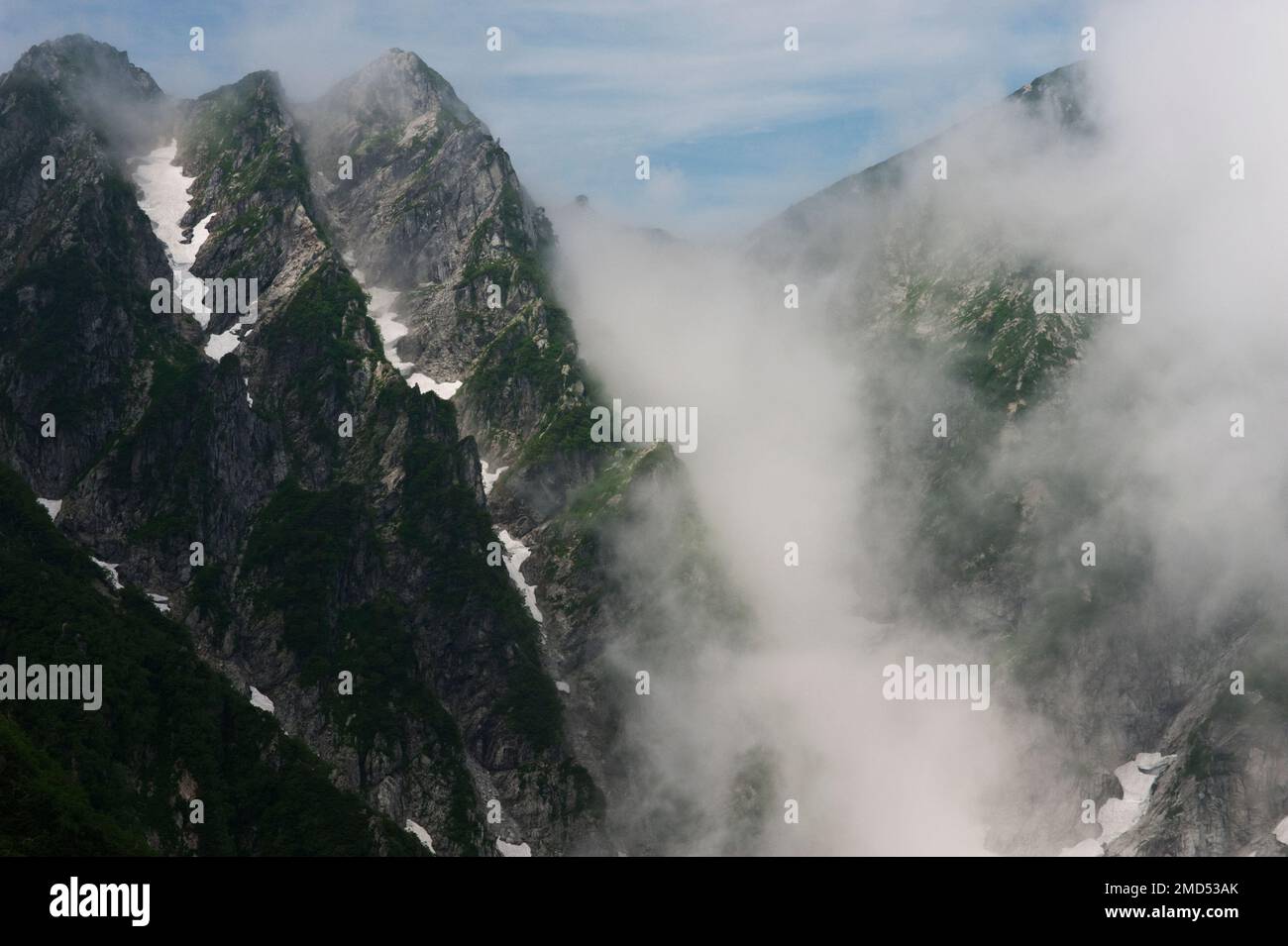 The North Japan Alps near Mount Goryu are rugged and shrouded in cloud ...