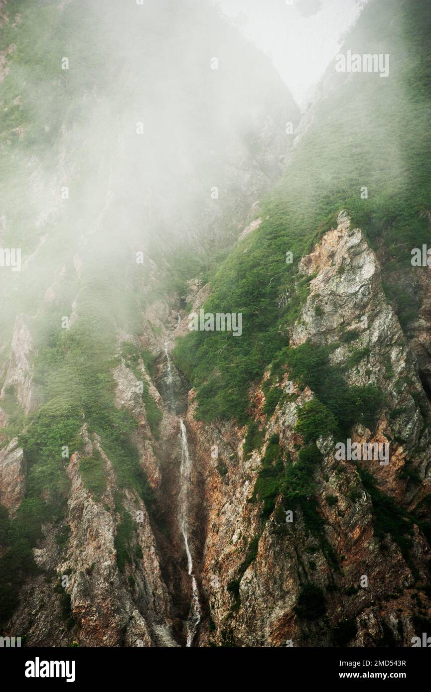 The North Japan Alps near Mount Goryu are rugged and shrouded in cloud ...