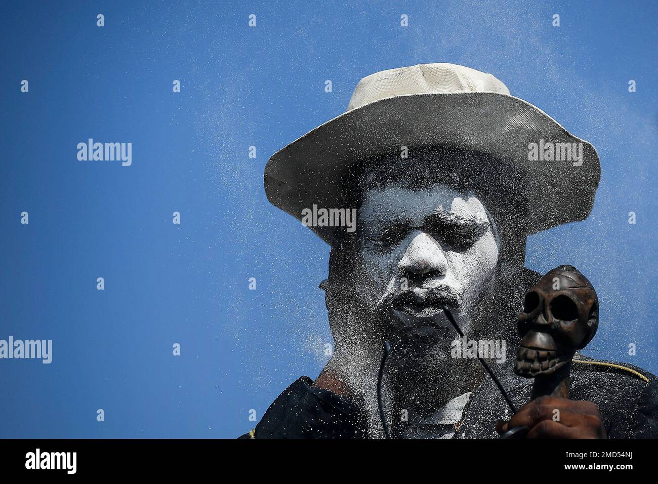 A person believed to be possessed with the Gede spirit attends a ...