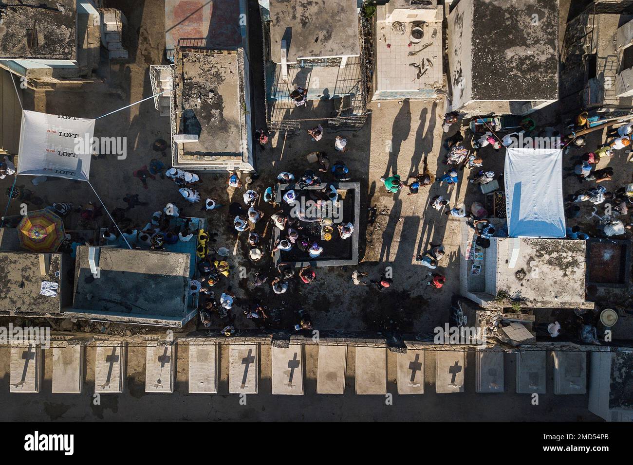 People gather at the tomb of Baron Samedi and Gede during a ceremony ...