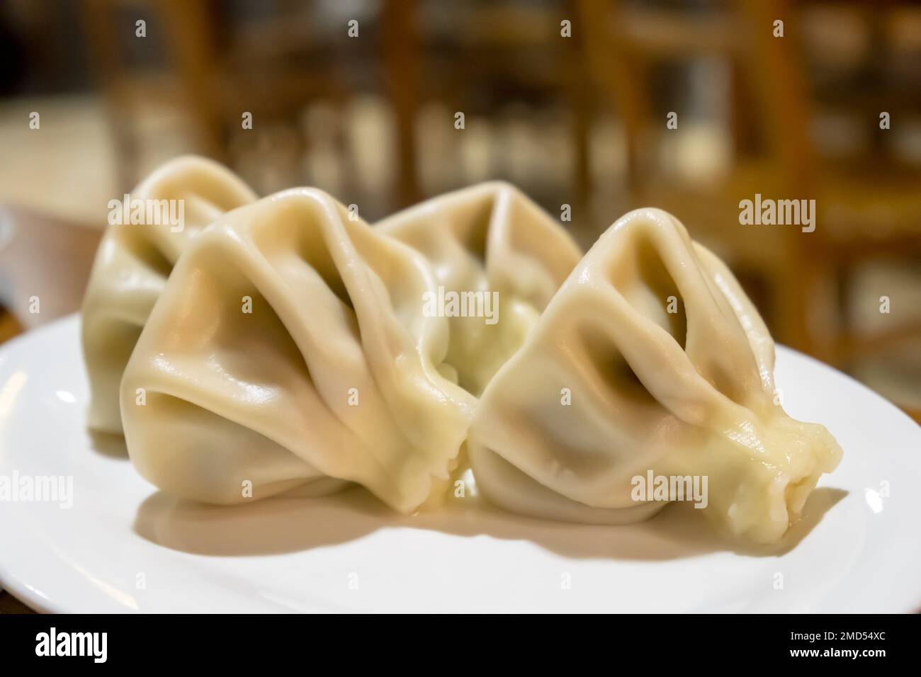 Khinkali filled with minced meat on white plate. Close-up of ...