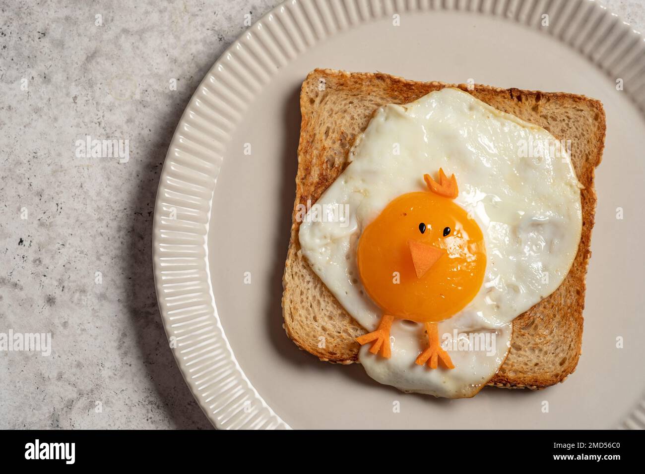 Funny toast with fried eggs in a shape of chicken Stock Photo - Alamy