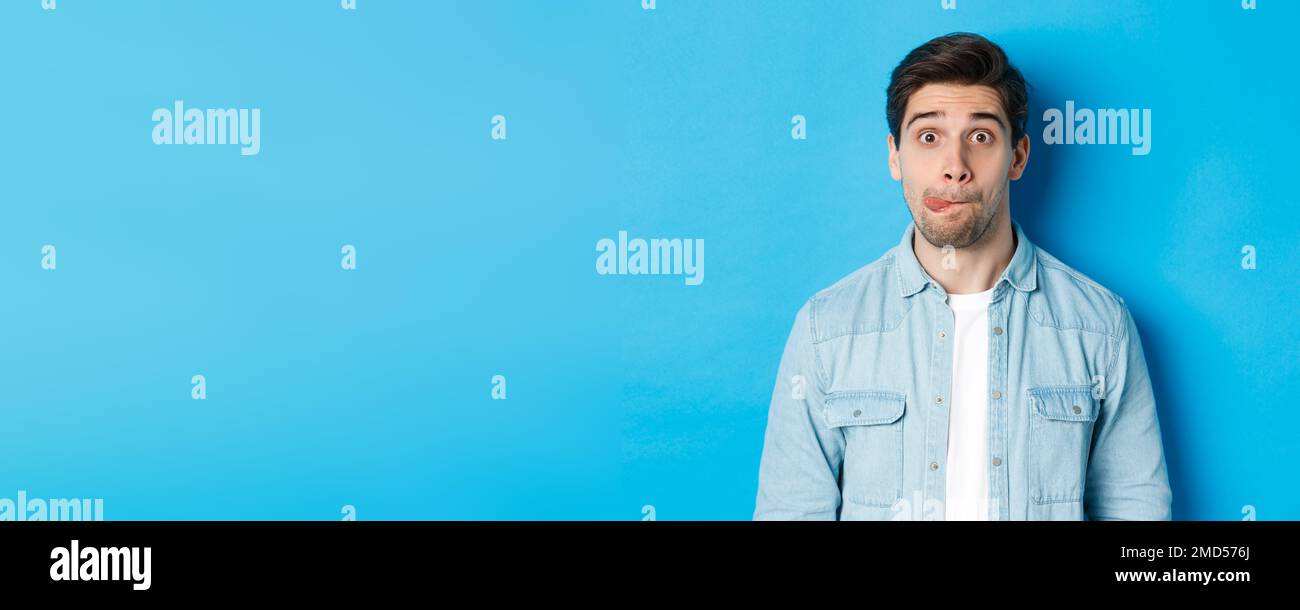 Close-up of young man making funny expressions, showing tongue and ...