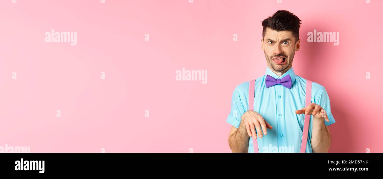 Funny guy looking at something disgusting with aversion and cringe ...